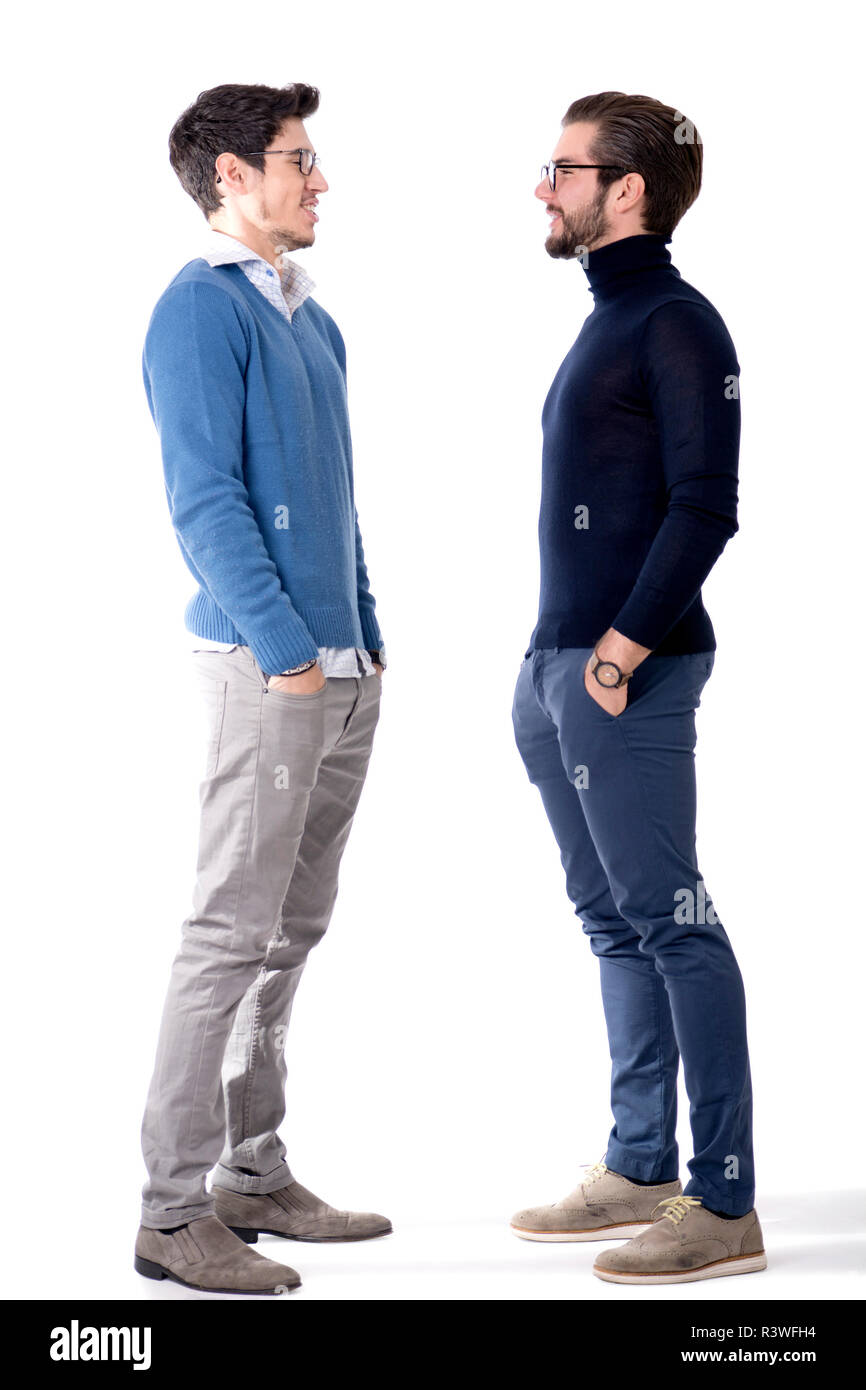 Two good-looking young men with eye-glasses in stylish clothes, looking ...