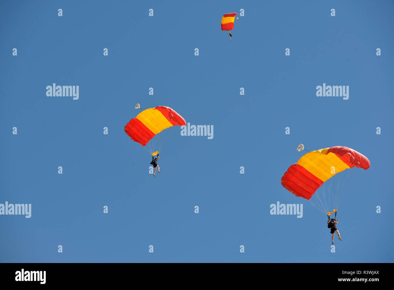 USA, Arizona, Eloy, people skydiving with orange and red parachutes ...