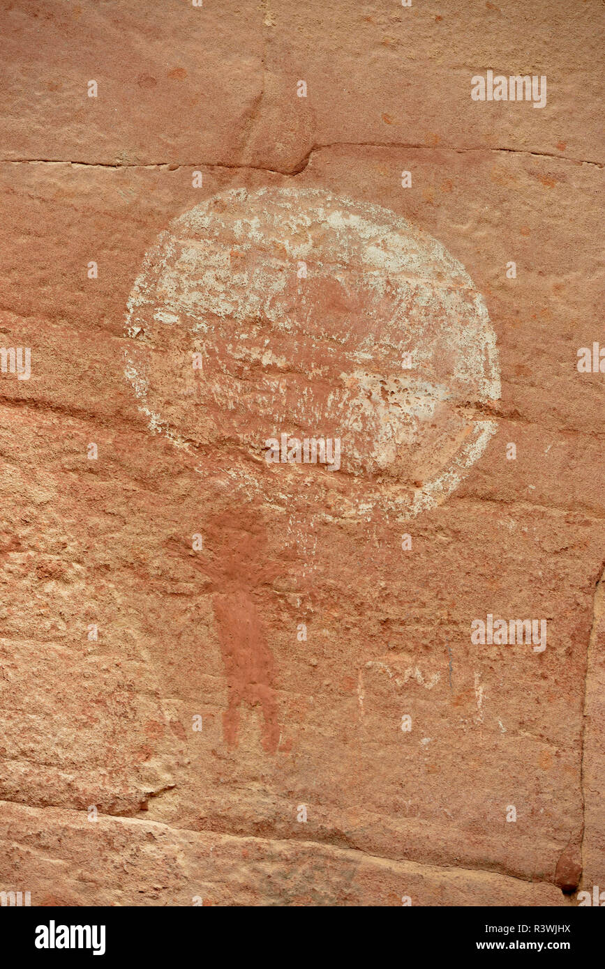 USA, Arizona, Sedona. Man worshiping the full moon petroglyph at the ...