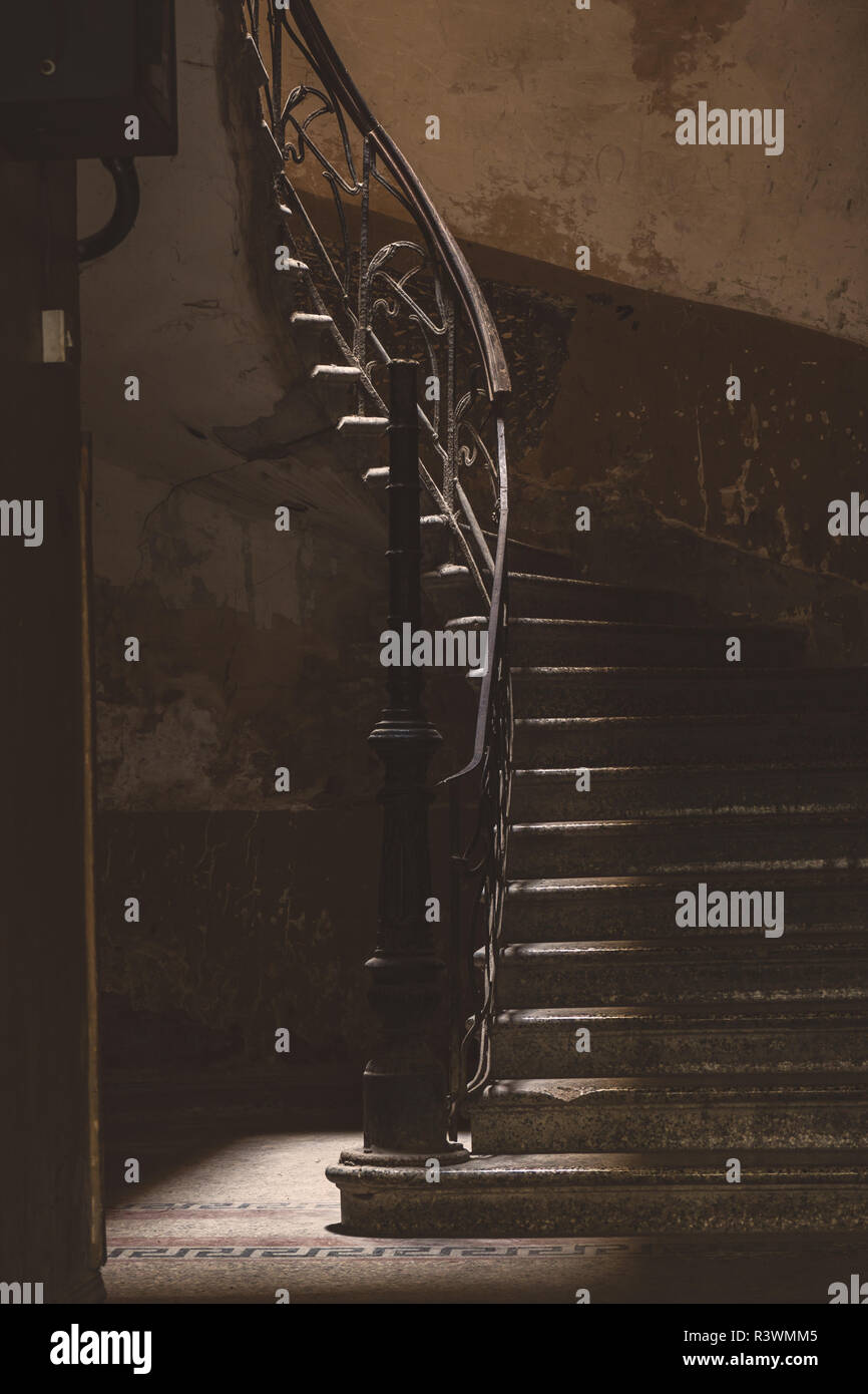 Old spiral staircase with forged iron decor in old house of downtown of ...