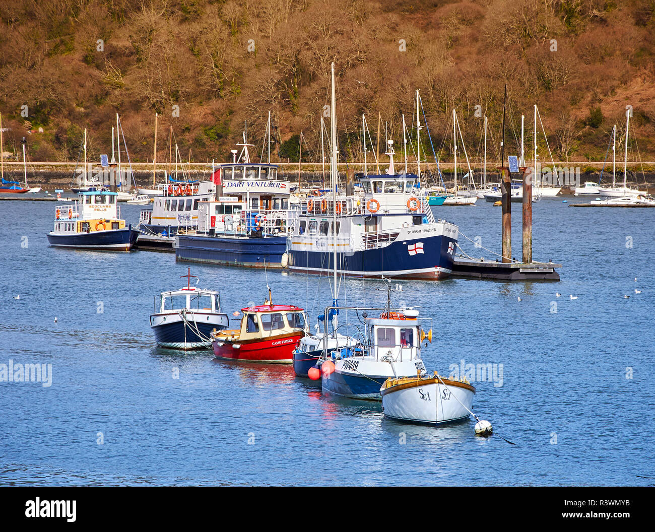 Small motor boats on trot moorings and larger passenger ferries moored ...