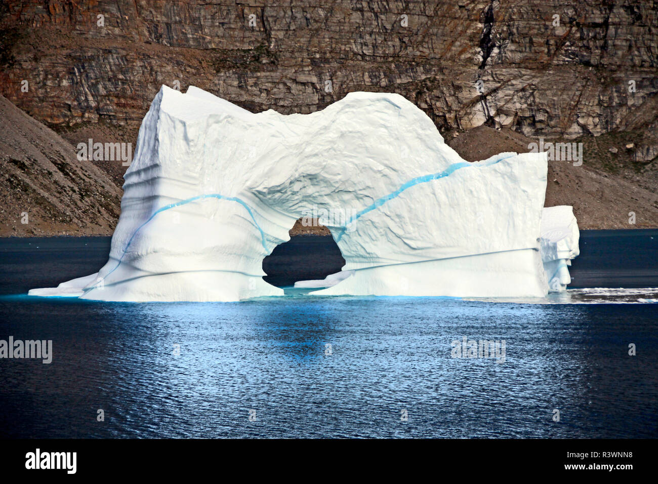 Greenland, Disko Bay, floating iceberg with a natural arch from the Ilulissat Kangerlua Glacier ...