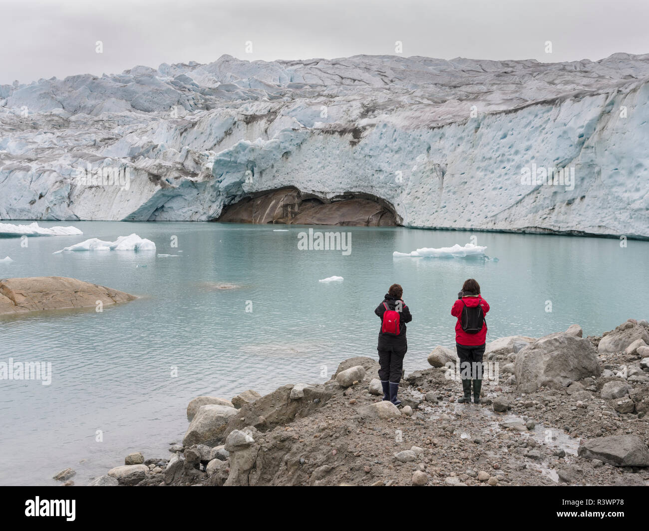 Tourists near the glaciers in the Qalerallit Imaa Fjord. Southern ...