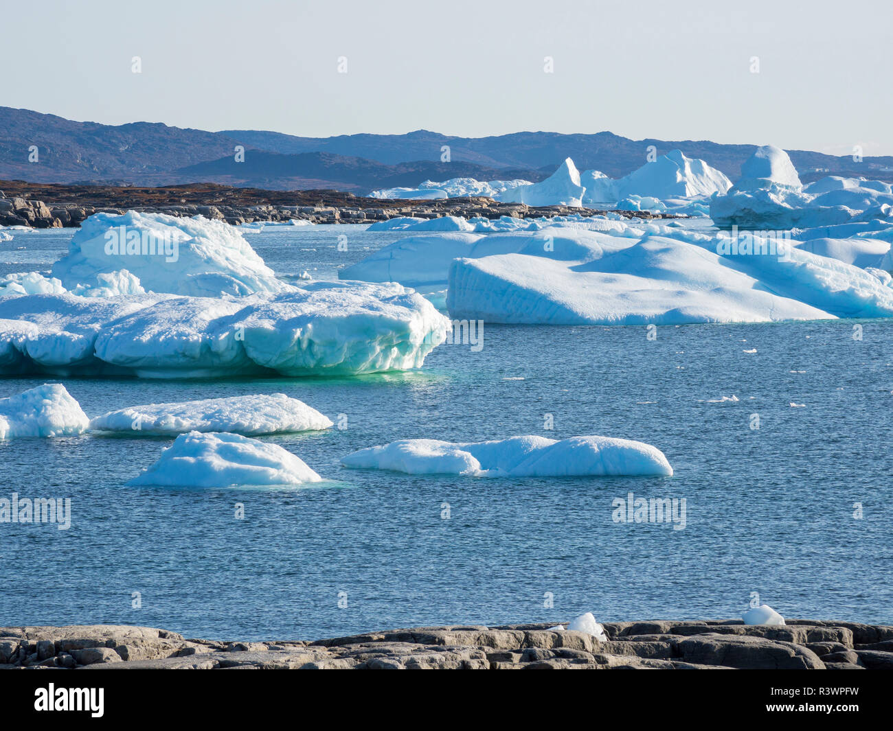 Coastal landscape with Icebergs. Inuit village Oqaatsut (once called ...