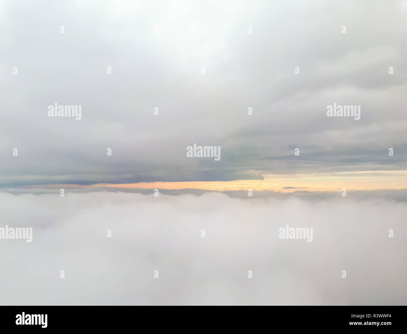 A front view of many clouds from an airplane with a wide cumulus clouds ...