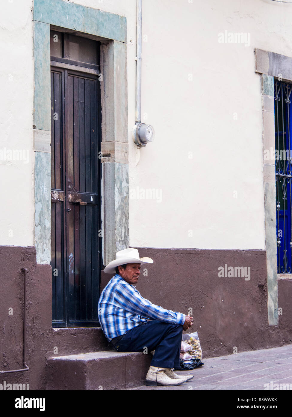 Mexico, Guanajuato, Cowboy sitting on steps Stock Photo - Alamy