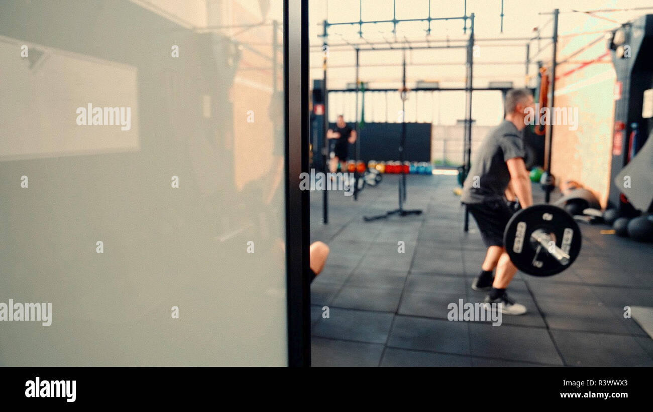 Man performing pull ups with heavy weights. Fitness exercise Stock ...