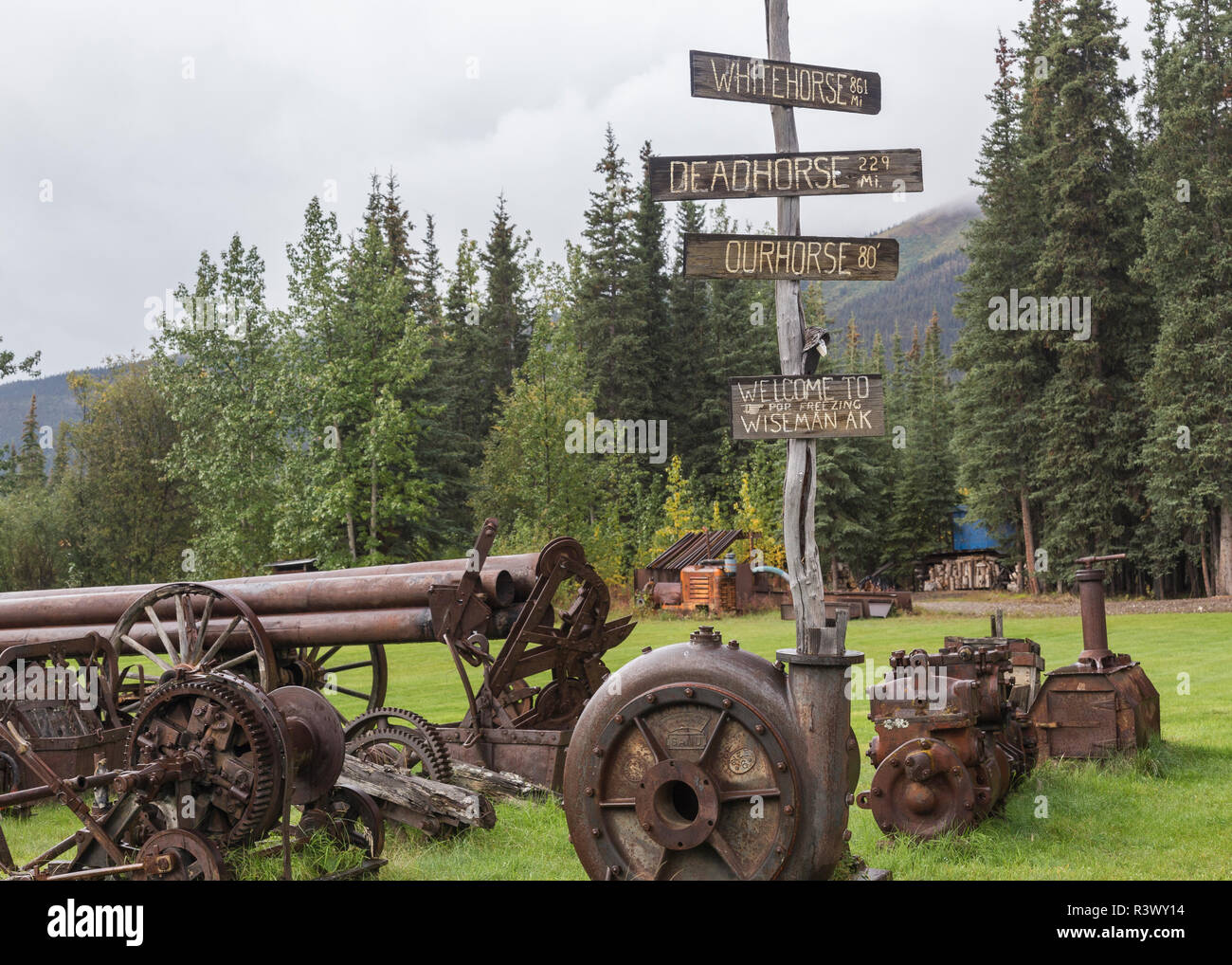 USA, Alaska, Wiseman. Mining relics and comic direction sign Stock ...