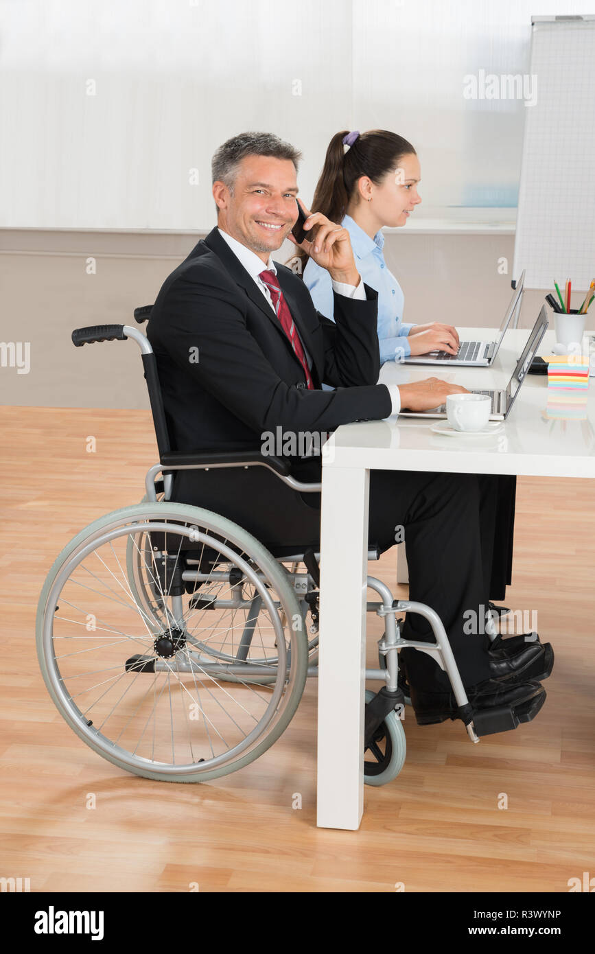 Disabled Businessman And Businesswoman In Conference Room Stock Photo ...