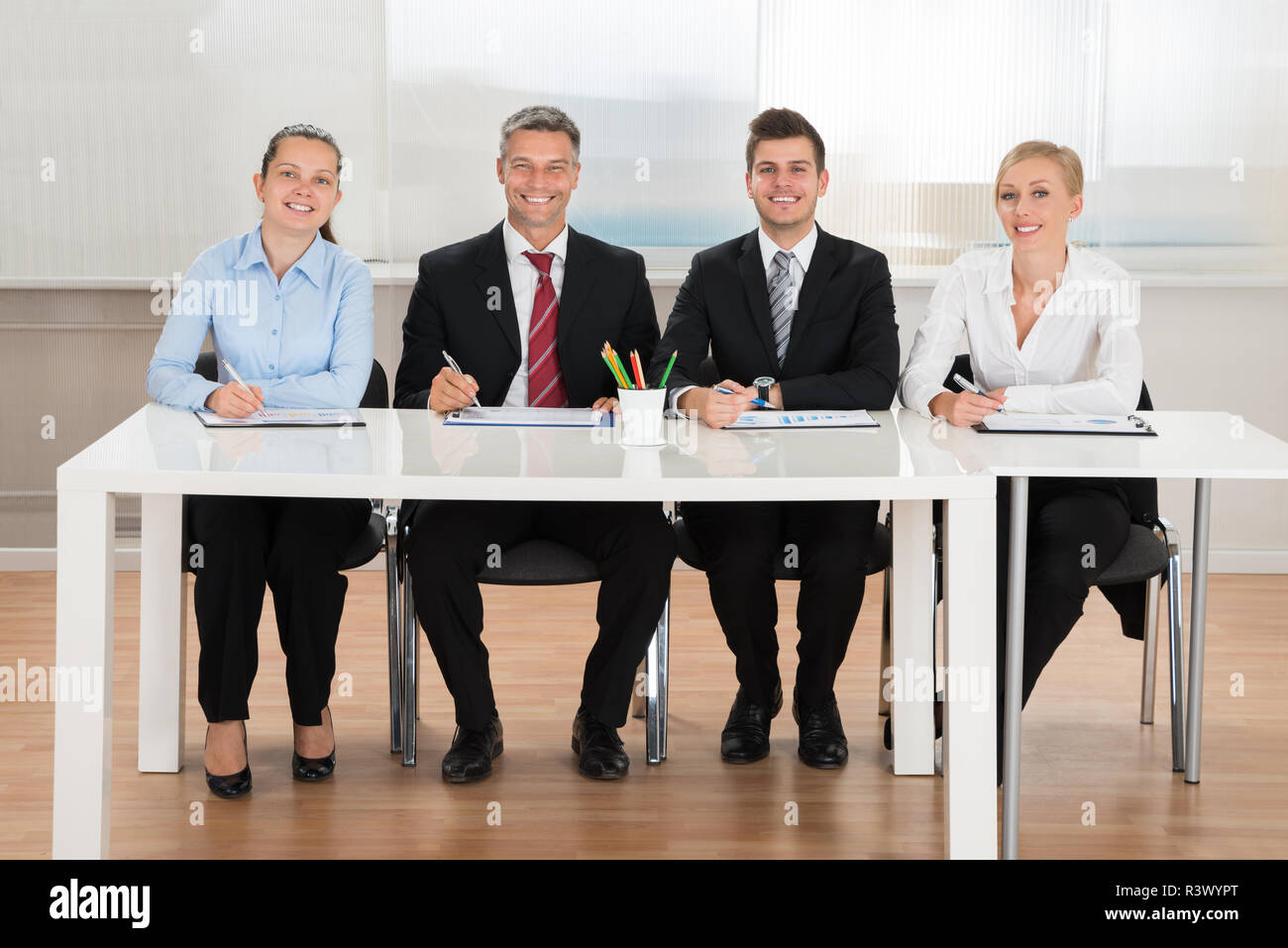 Happy Businesspeople Analyzing Graph Stock Photo - Alamy Happy Businesspeople Analyzing Graph Stock Photo - Alamy