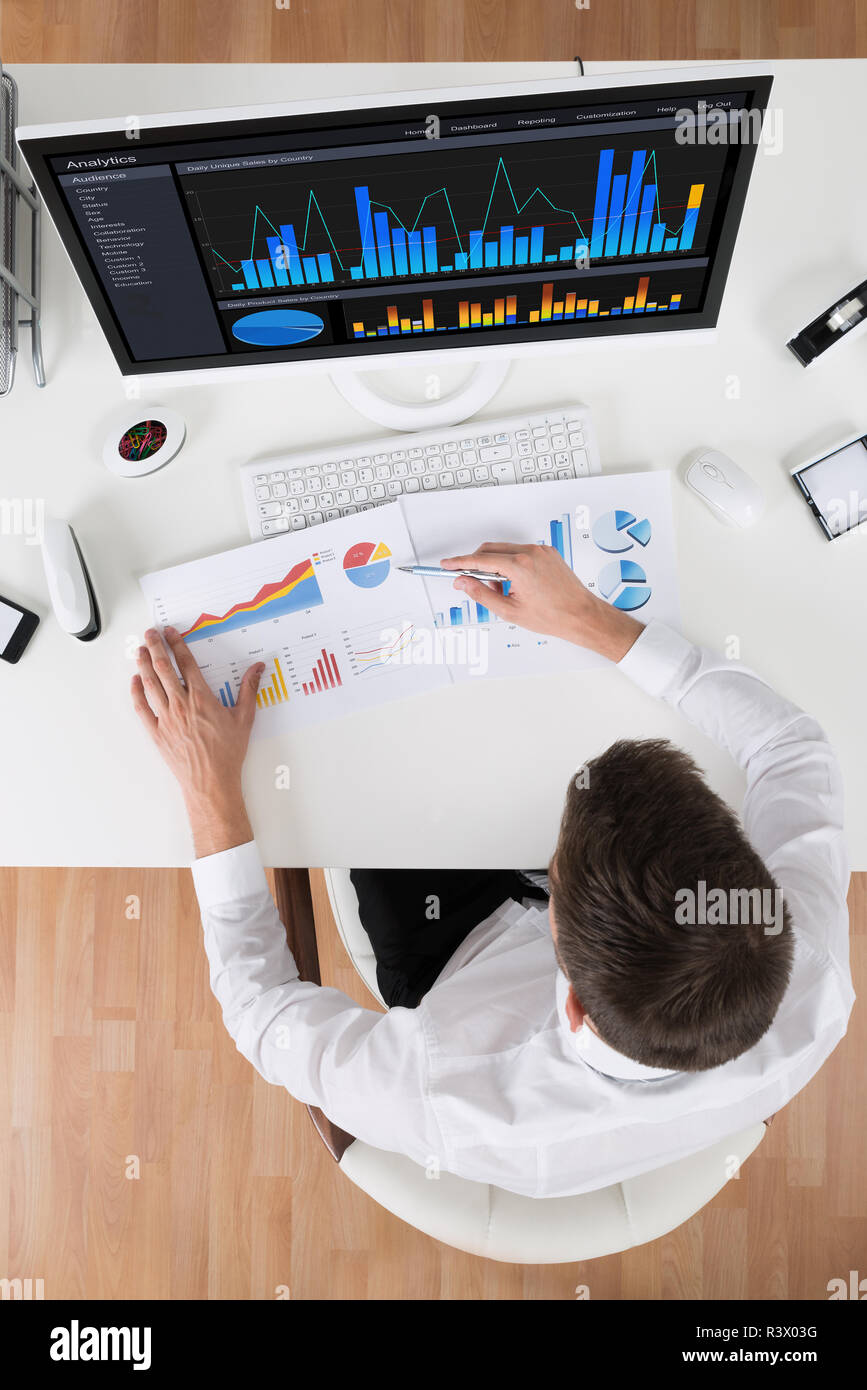 Businessperson analyzing graphs desk hi-res stock photography and ...