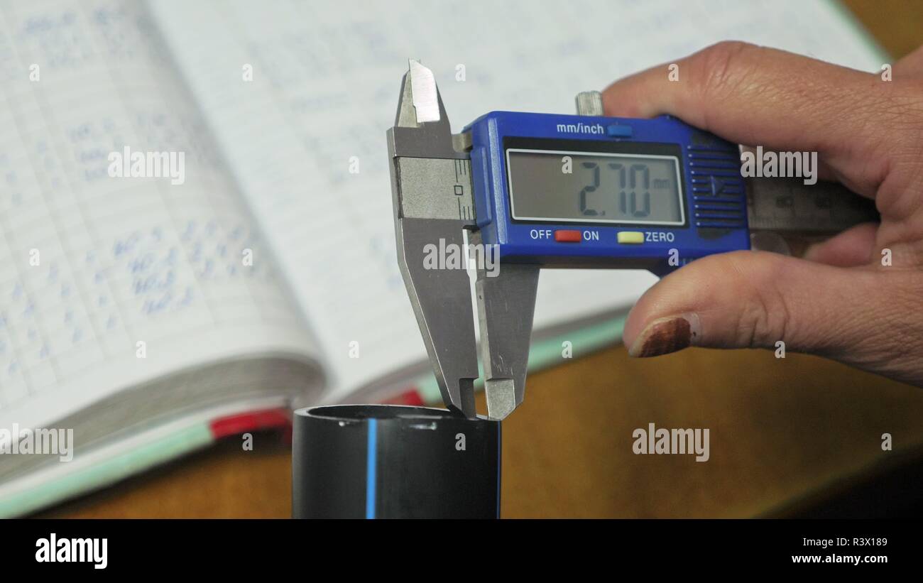 Electronic digital caliper. Manufacture of plastic water pipes of the ...