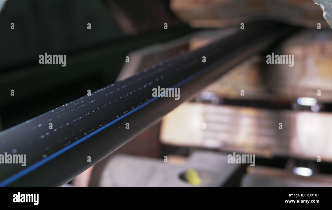 Pipes manufacturing production line. Manufacture of plastic water pipes ...
