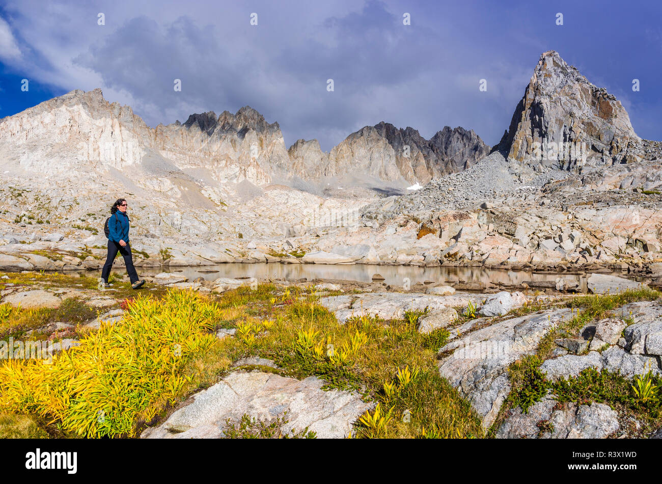 Hiker under Isosceles Peak and the Palisades in Dusy Basin, Kings ...