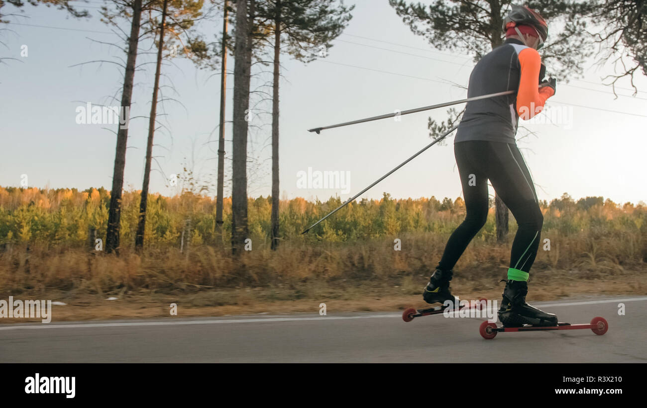 Training an athlete on the roller skaters. Biathlon ride on the roller ...