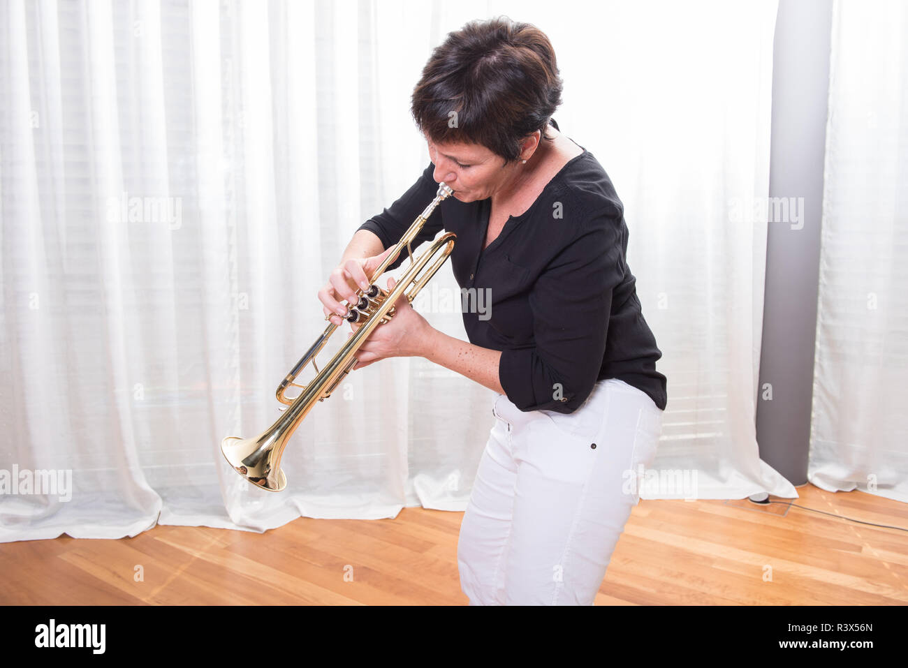 Woman playing trumpet hi-res stock photography and images - Alamy