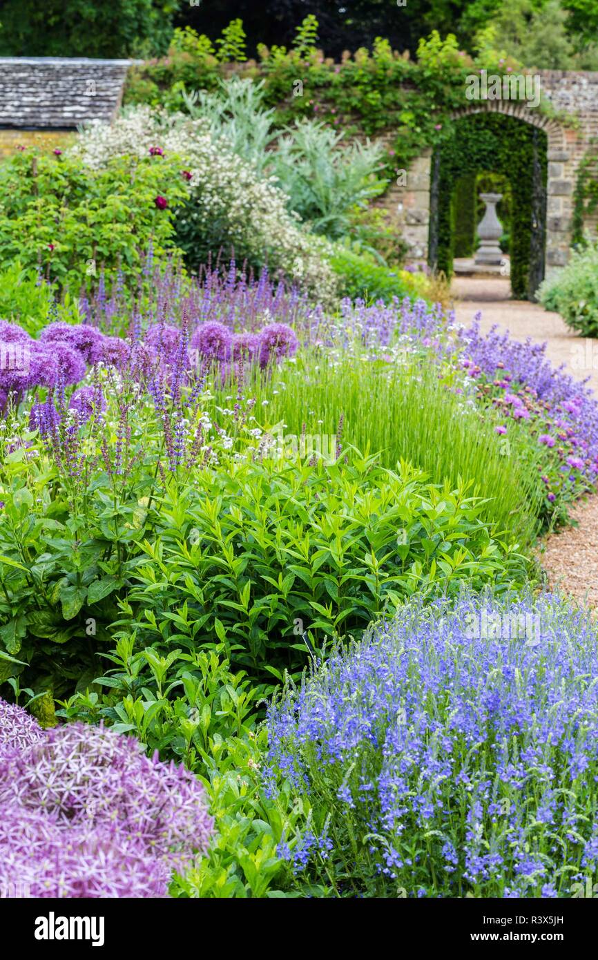 Colorful border in British castle garden during spring in Sussex ...