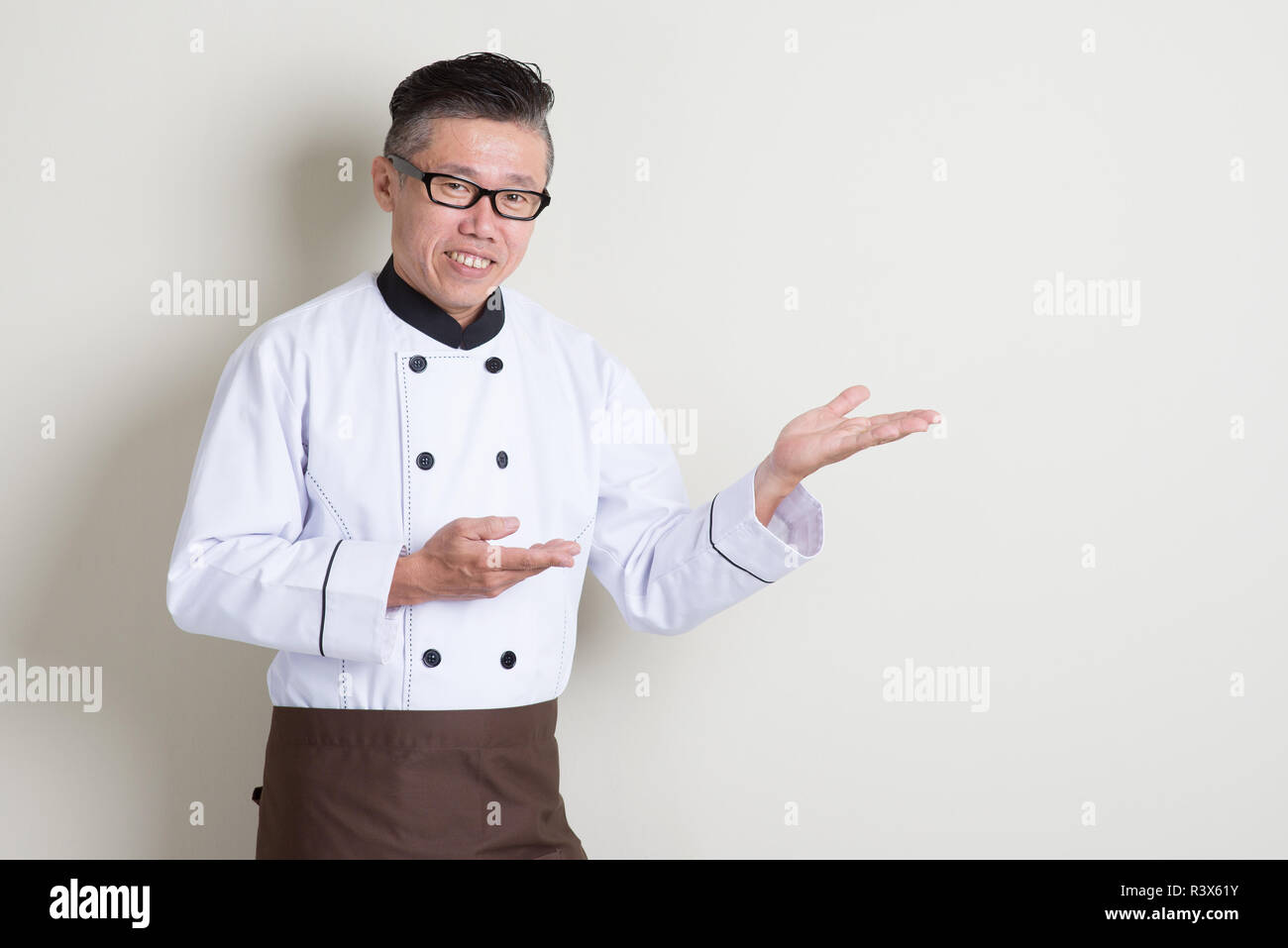 Happy chef showing something hi-res stock photography and images - Alamy
