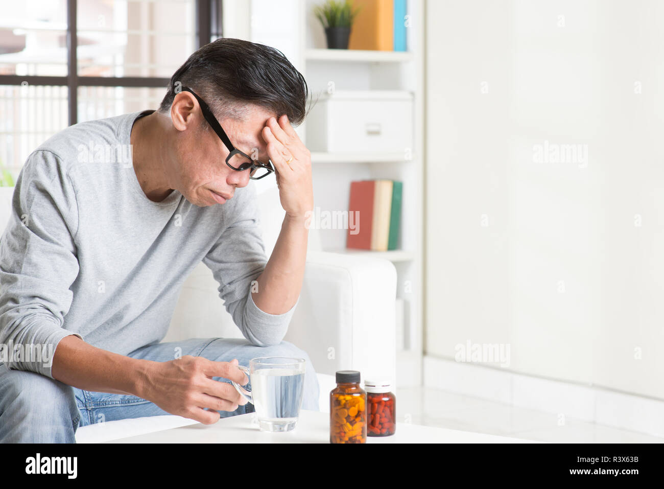 Mature Asian Chinese man headache Stock Photo - Alamy