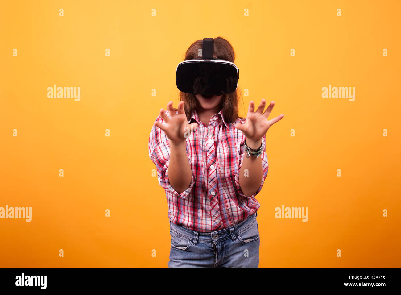 Girl in jeans dancing while she has her VR on. Dancing time Stock Photo ...
