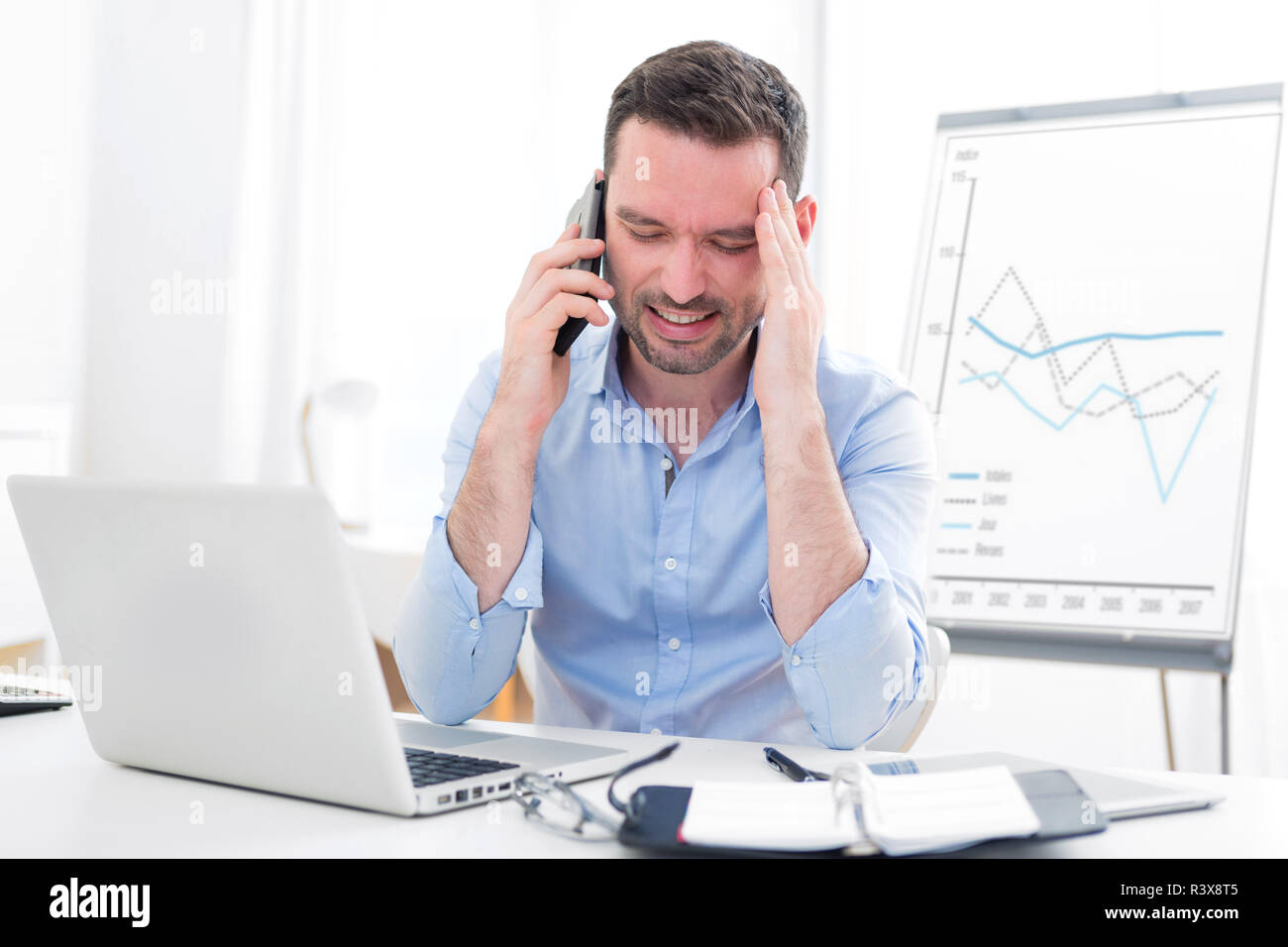 Young attractive business got headache because of mobile phone Stock ...