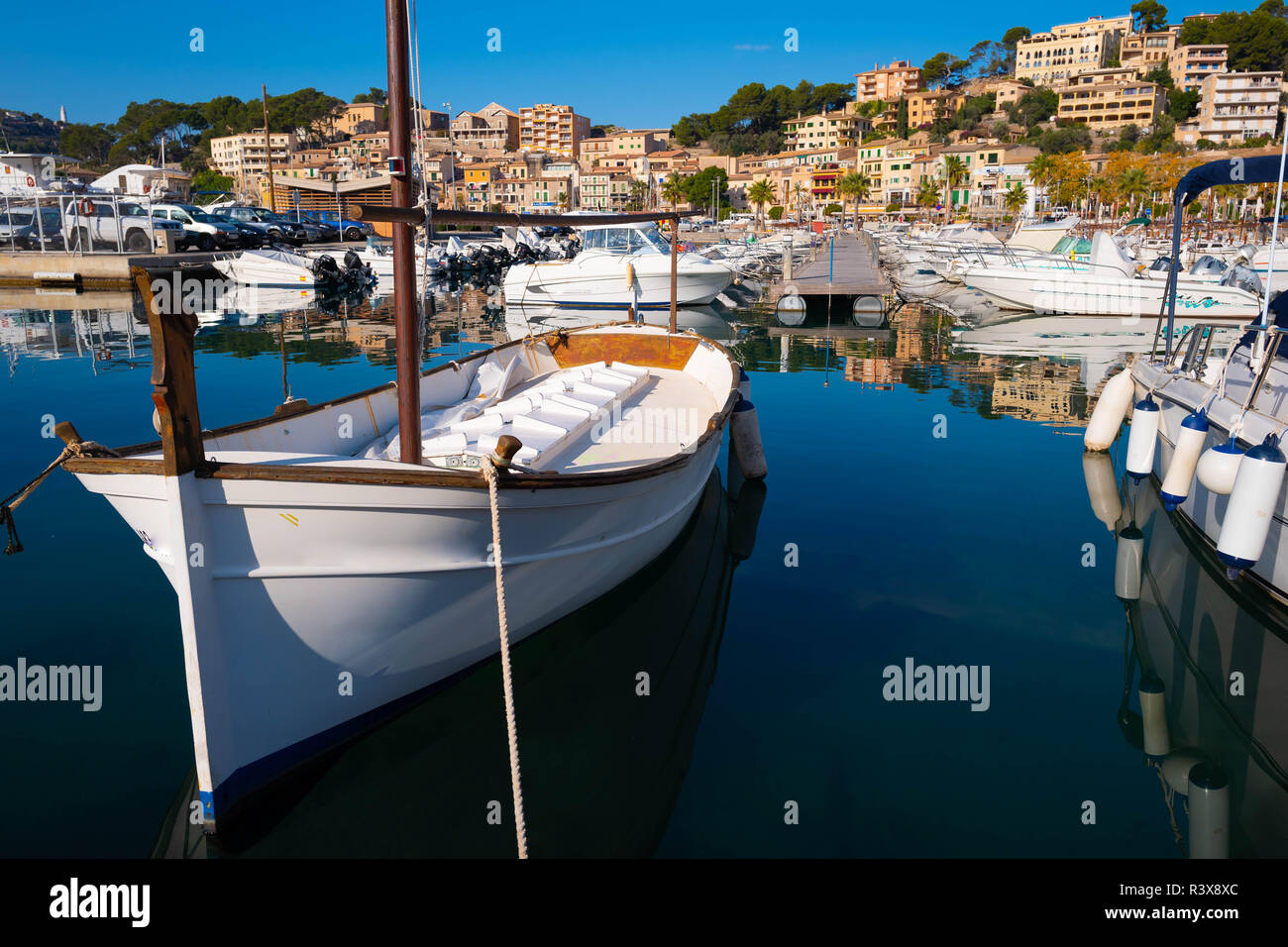 Small white boat anchored in the harbor surrounded by other boats Stock ...