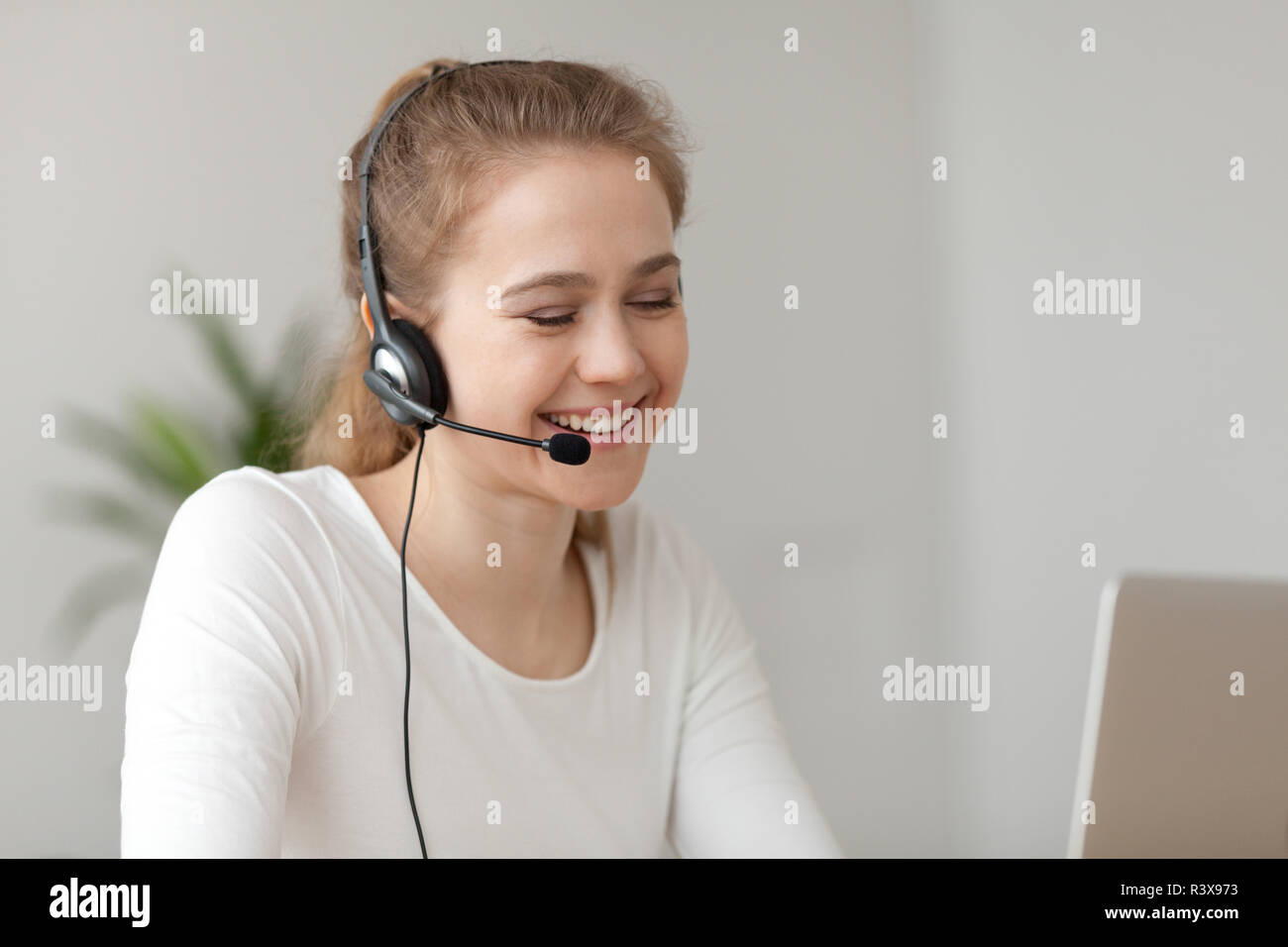 Smiling girl wearing headset talking or making video call Stock Photo ...