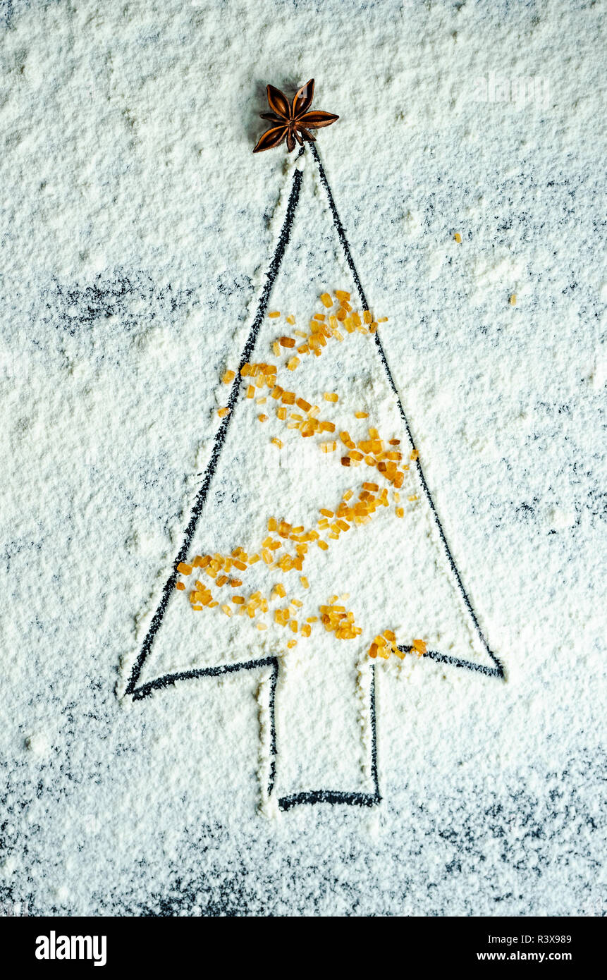 Christmas card with xmas tree made with flour on dark background with ...