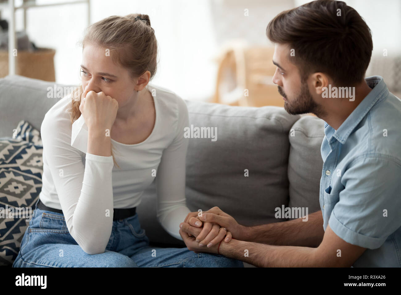 Caring husband hold wife hand making peace after fight Stock Photo - Alamy
