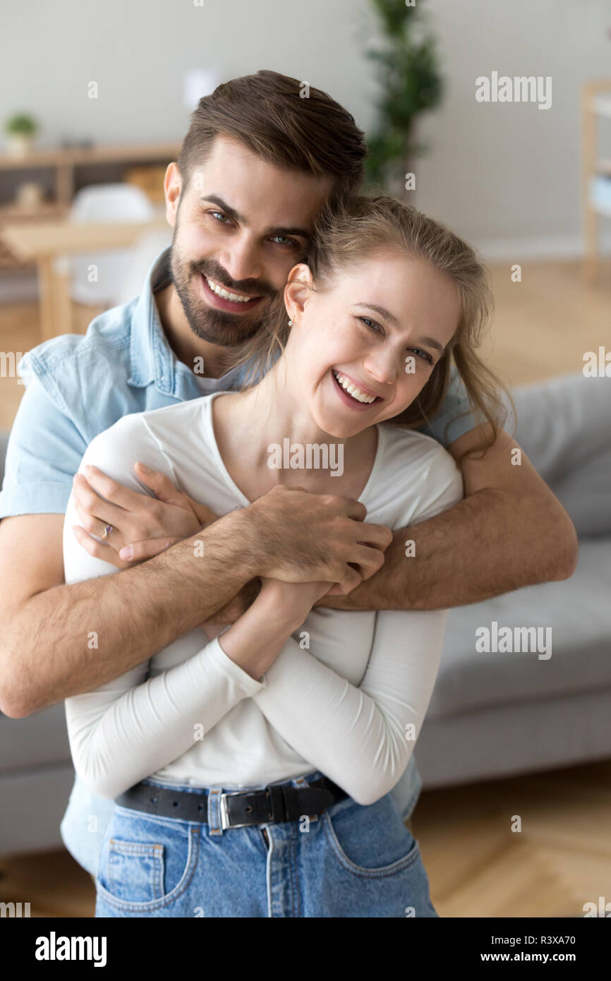 Portrait of smiling husband hold in arms young happy wife Stock Photo ...