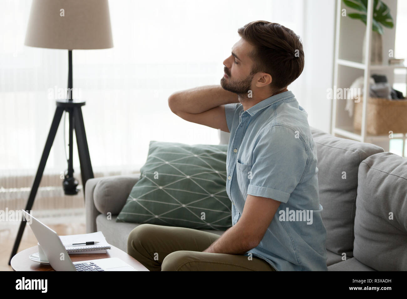 Tired man massaging neck suffering from sedentary lifestyle Stock Photo ...