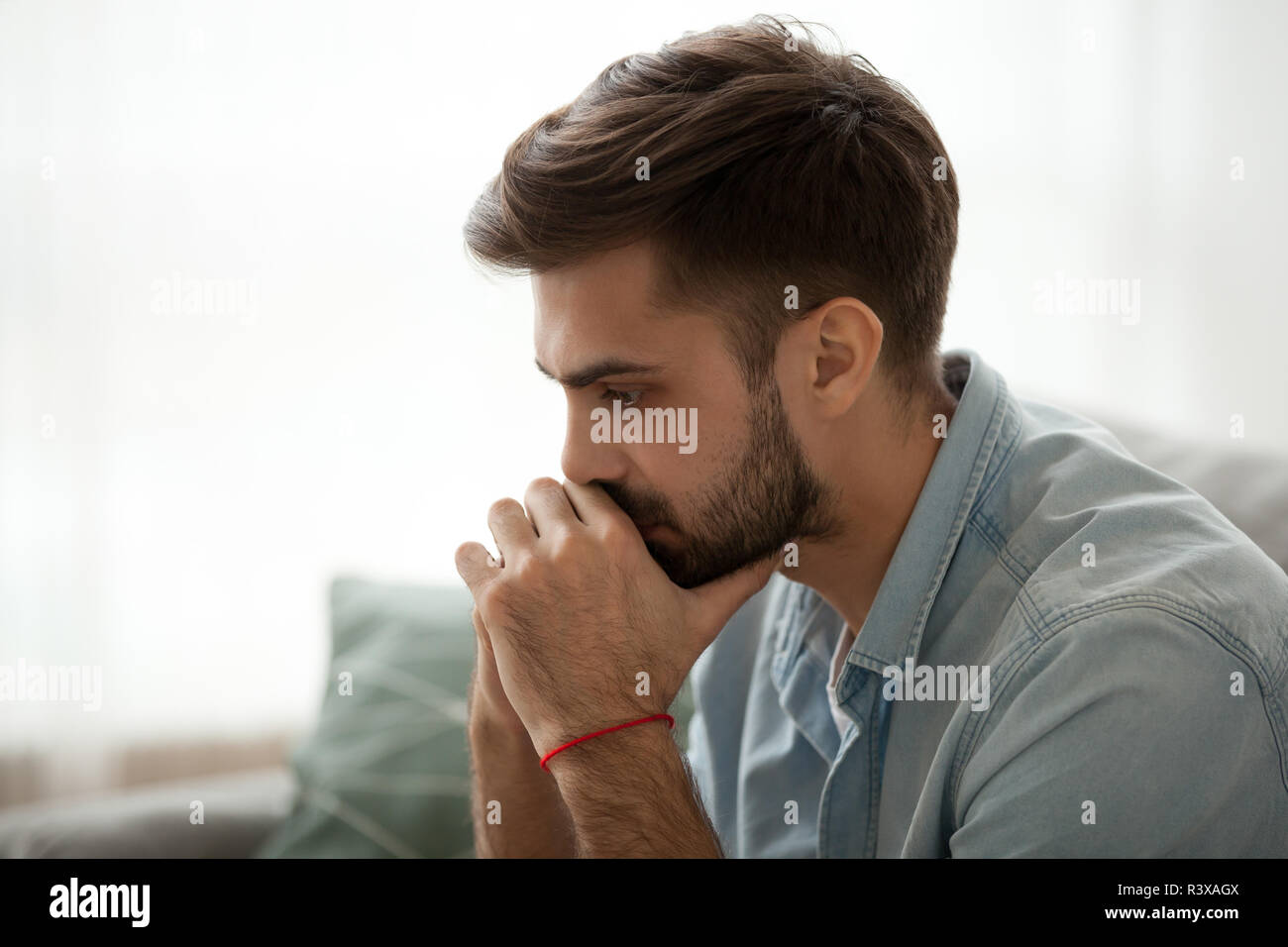 Serious millennial man thinking of problem solution Stock Photo - Alamy