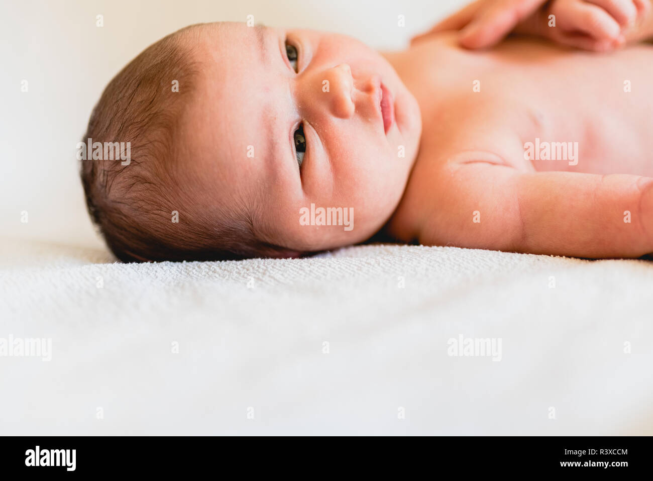 Little baby resting relaxed lying thoughtful Stock Photo - Alamy
