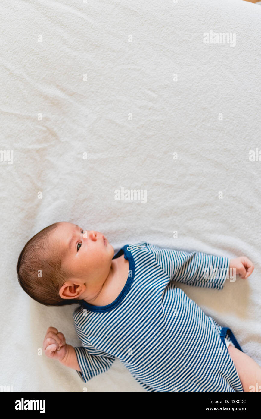 Little baby resting relaxed lying thoughtful Stock Photo - Alamy