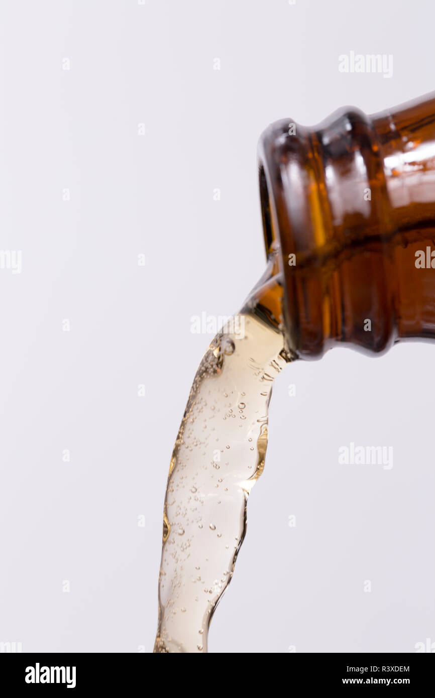 Beer Pouring out of Bottle Stock Photo - Alamy