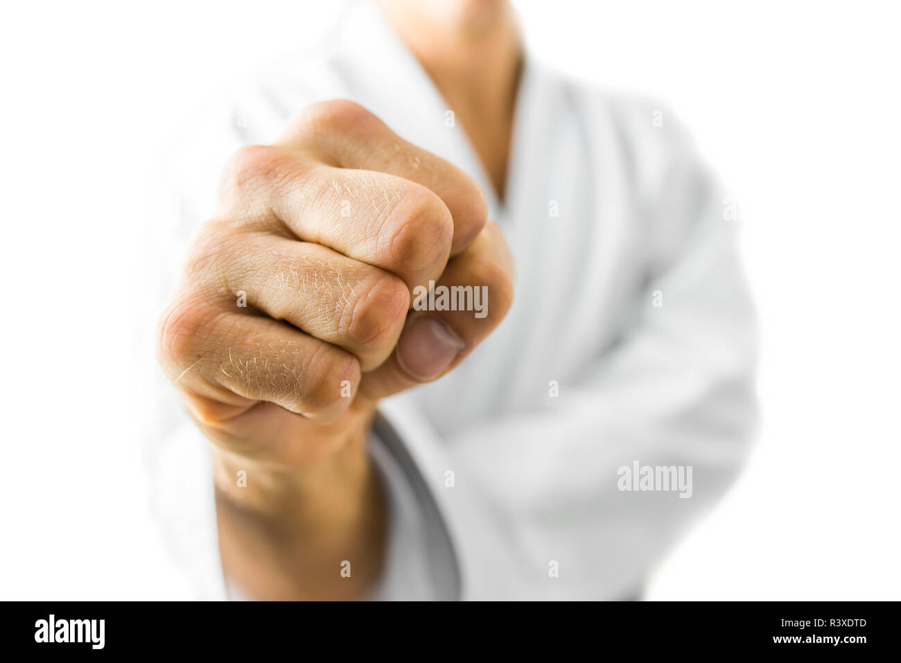 Closeup of male karate fighter making a fist. Isolated over white ...