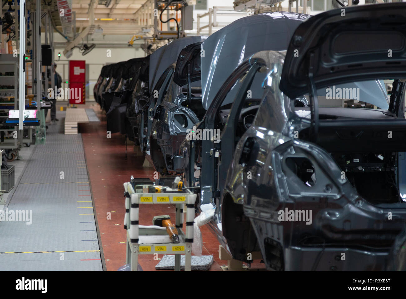 Add details to car body. Robotic equipment makes Assembly of car ...