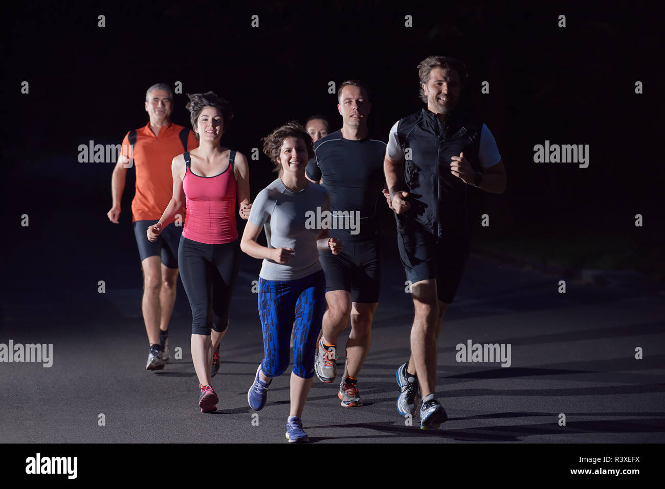 people group jogging at night Stock Photo - Alamy