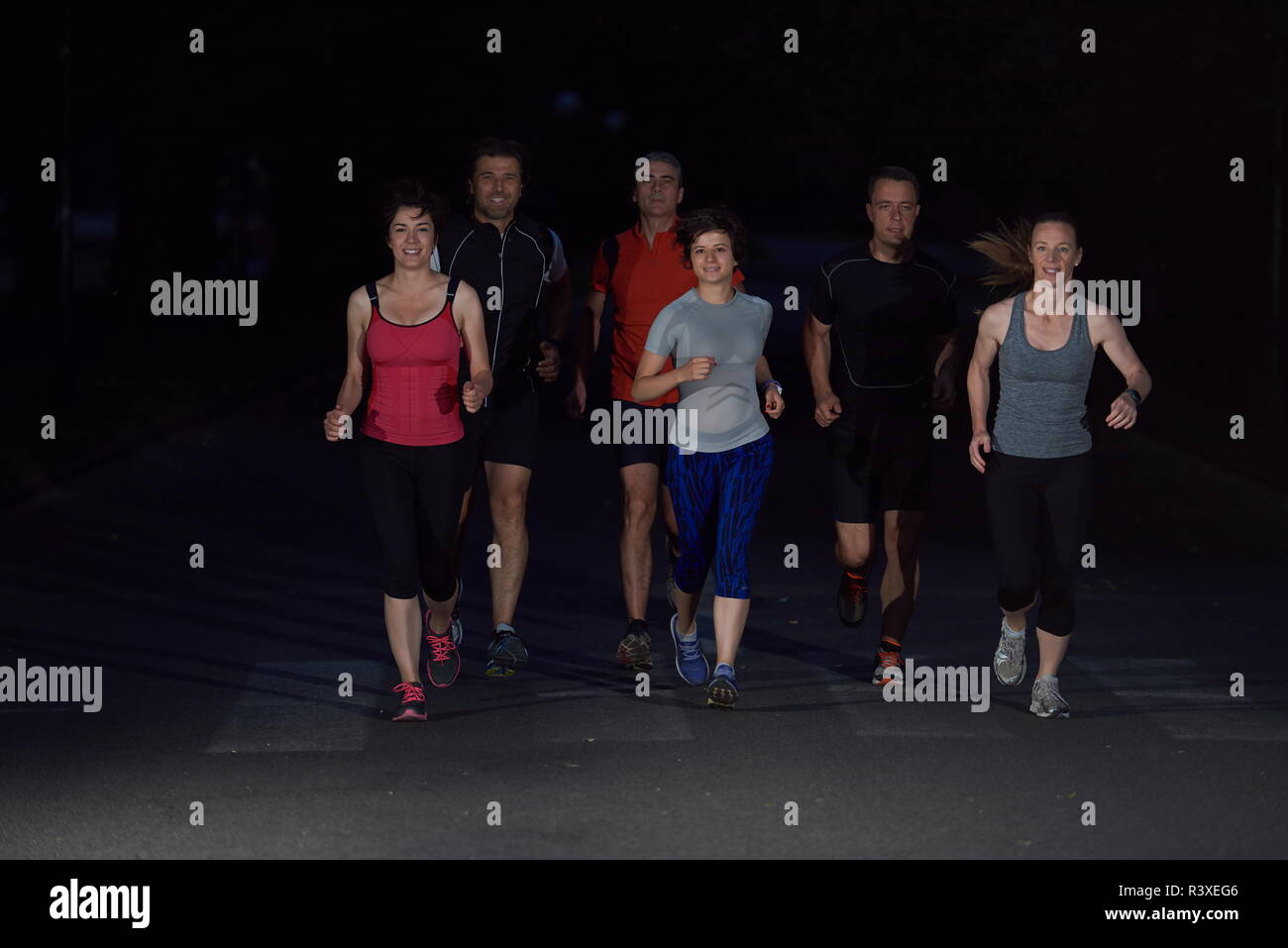 people group jogging at night Stock Photo - Alamy