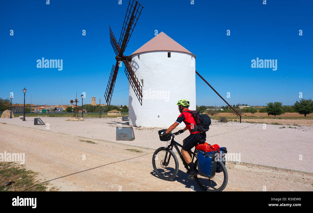 Biker pilgrim by Camino de Santiago in bicycle at windmill of Castile ...