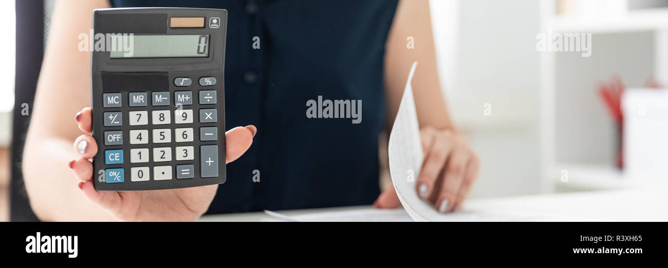 Women's hands holding a calculator Stock Photo - Alamy