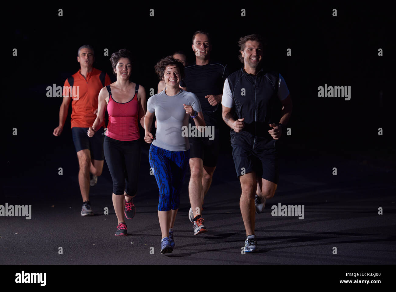 people group jogging at night Stock Photo - Alamy