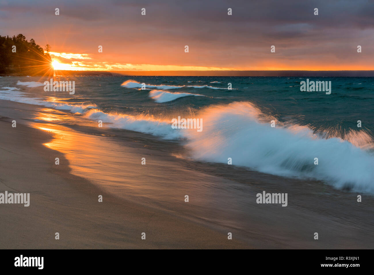 Dramatic sunset light along Miners Beach in Pictured Rocks National ...