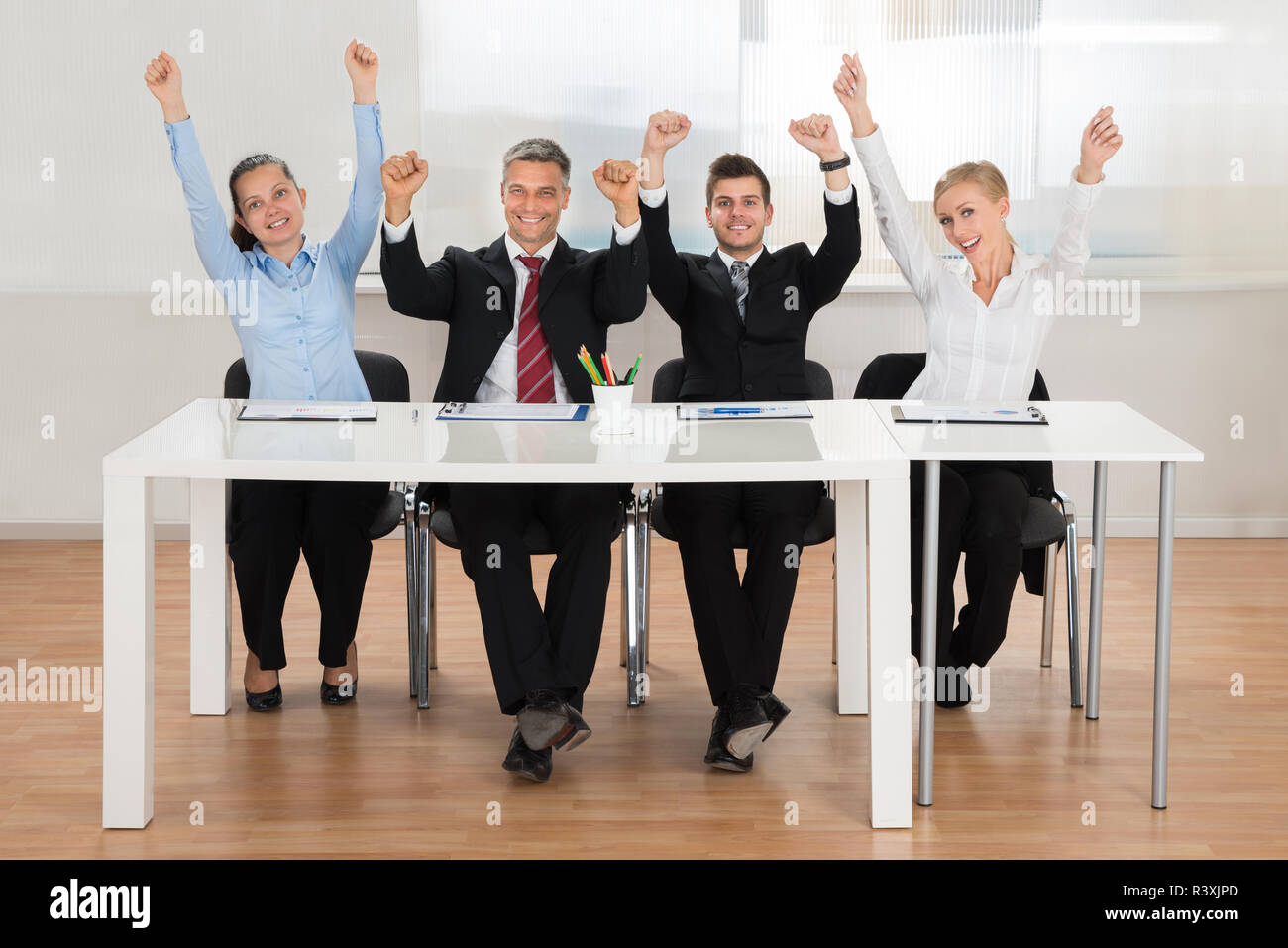 Excited business team celebrates success hi-res stock photography and ...