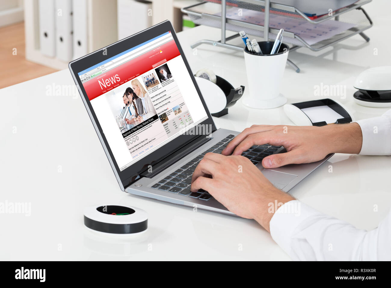 Businessperson Checking Online News On Laptop Stock Photo - Alamy