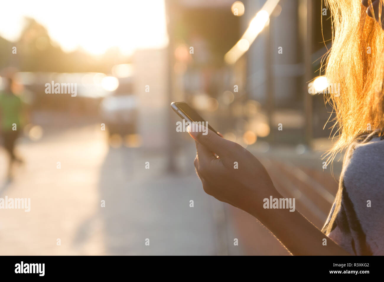 Closeup woman using smartphone sunset hi-res stock photography and ...