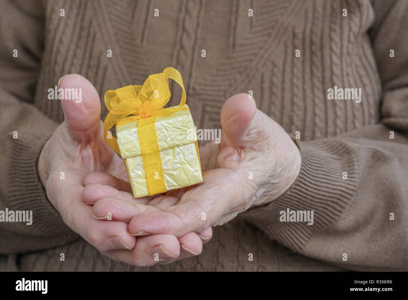 Grandma holding wrapped gift hi-res stock photography and images - Alamy