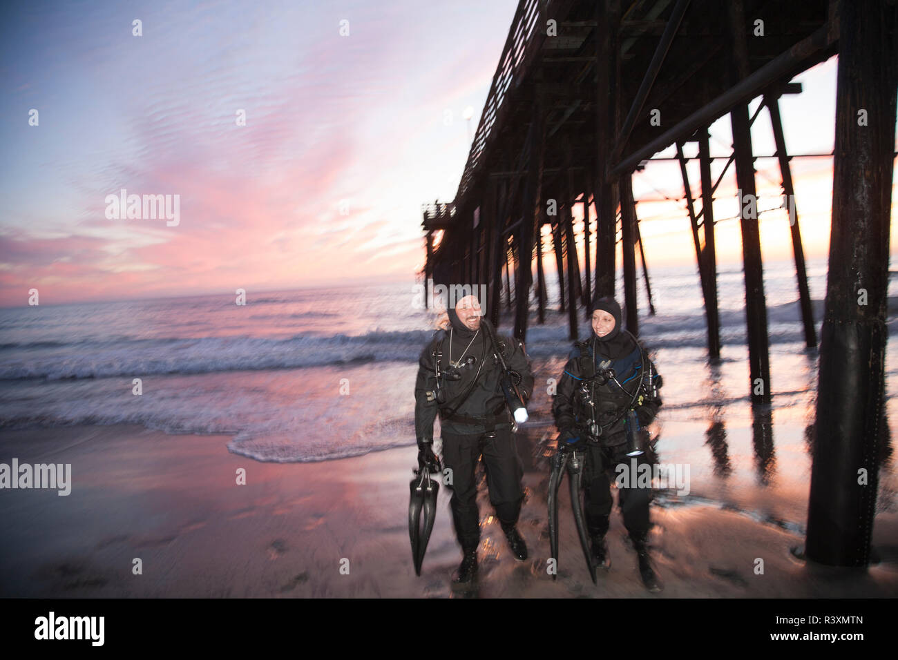 Scuba Divers in drysuit at Sunset, Oceanside Pier, Oceanside, North of ...