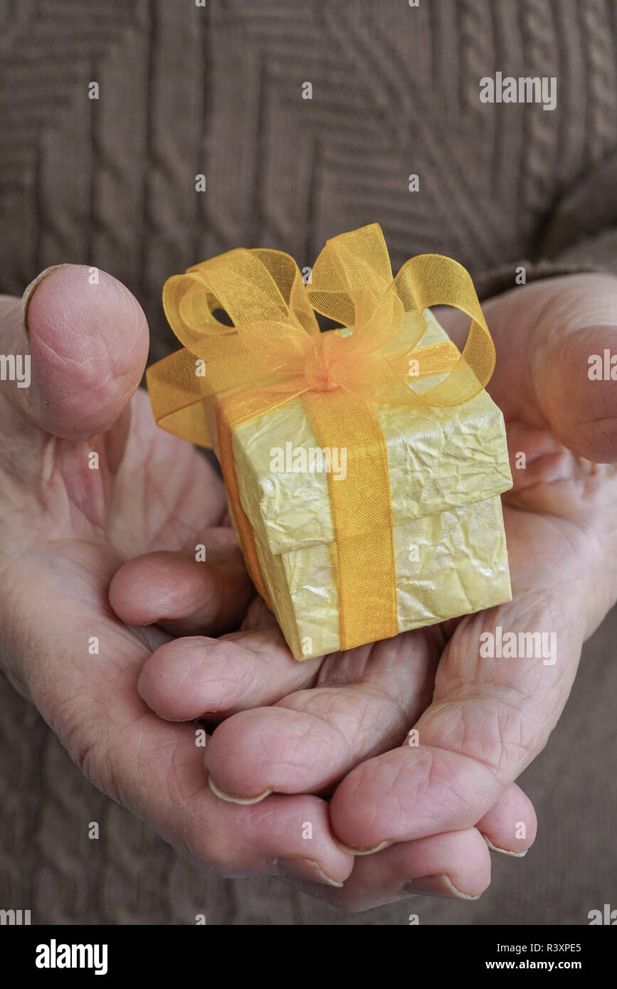 Grandma holding wrapped gift hi-res stock photography and images - Alamy