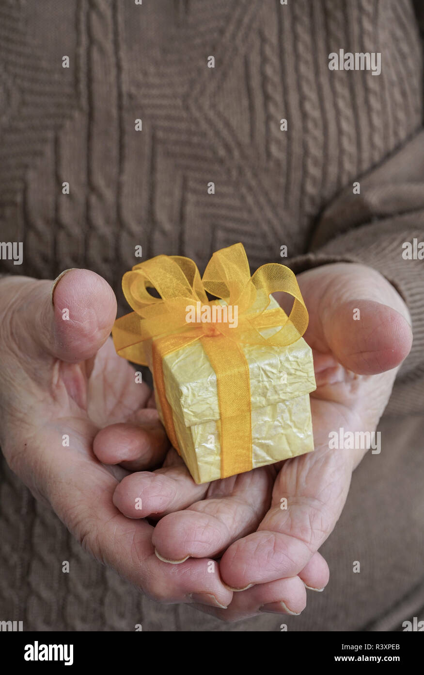 Grandma holding wrapped gift hi-res stock photography and images - Alamy